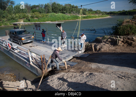 The hand-pulled car ferry which crosses the Rio Grande river between ...
