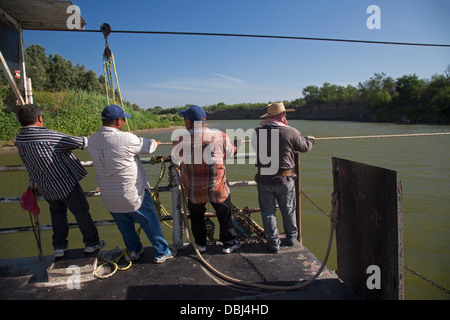 The hand-pulled car ferry which crosses the Rio Grande river between ...
