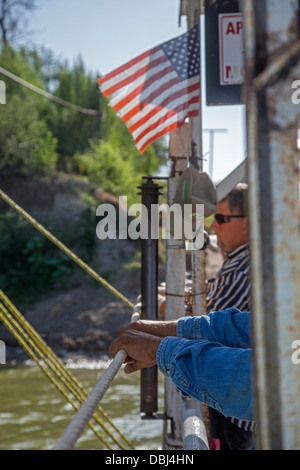 The hand-pulled car ferry which crosses the Rio Grande river between ...