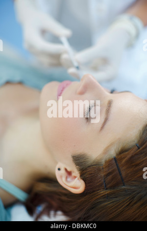 Woman is getting botox injection. Anti-aging treatment and face lift ...