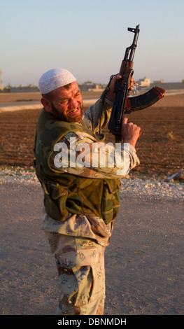 A Free Syrian Army rebel fires his AK-47 into the air in Aleppo, Syria ...