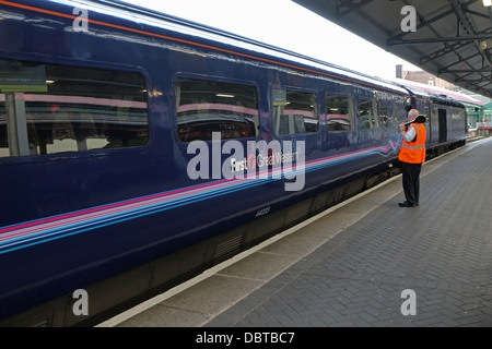 Station manager signaling train departure on Platform at Swansea ...