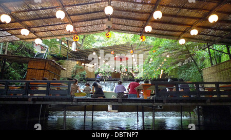 A 'kawadoko' dining deck built over a river running through Kibune in ...