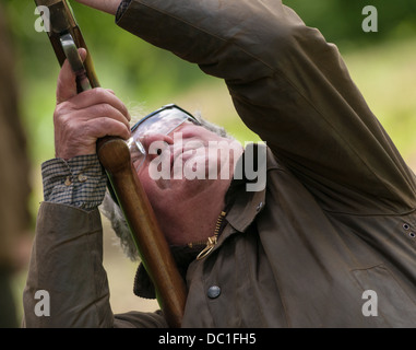 Man shooting at a simulated game shooting clay shoot wearing tweed cap ...