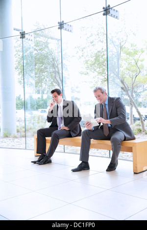 Businessmen using a digital tablet in office Stock Photo - Alamy