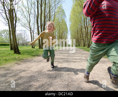 Children running in the park Stock Photo - Alamy