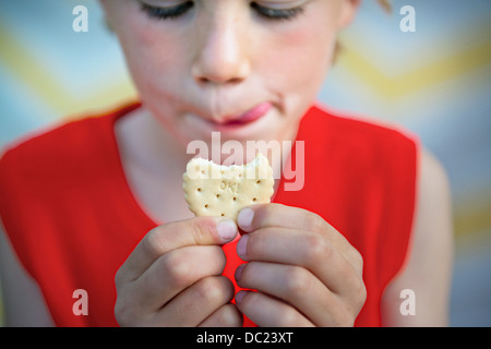 Boy eating biscuit Stock Photo - Alamy
