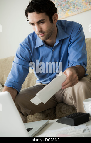 Man paying bills online Stock Photo - Alamy