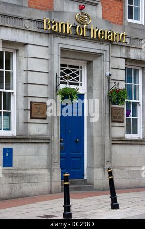 Facade of Bank of Ireland branch building lit by evening sunlight in ...