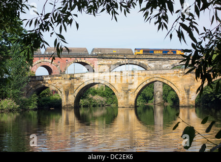 Freight train crossing the rail viaduct across the River Wansbeck near ...