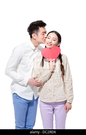 Young adult couple expressing love and affection while sitting on a ...