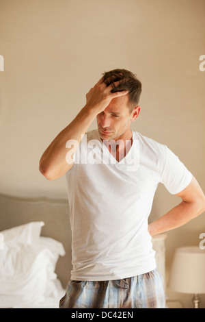 Man is in pain and holding his forehead Stock Photo - Alamy