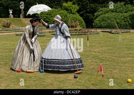 Victorian era recreation: well-to-do young ladies, one with parasol ...