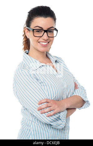 Bespectacled lady with folded arms standing sideways on white ...