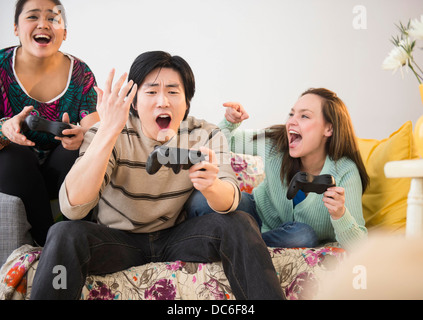 young Asian women playing video game using controller relaxing on ...