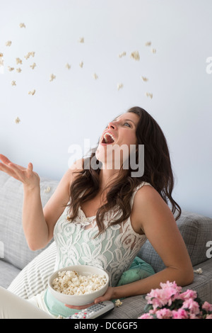 woman throwing up popcorn Stock Photo - Alamy
