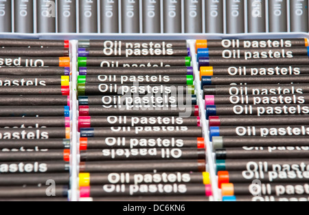 open box of oil pastels or crayons isolated white background ...