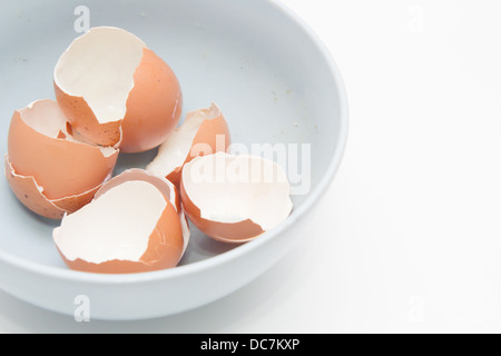 Heap of egg shell in a dirty bowl with white background Stock Photo - Alamy