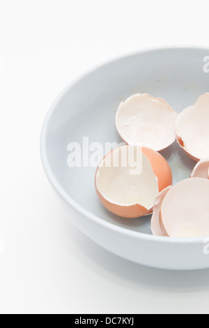 Heap of egg shell in a dirty bowl with white background Stock Photo - Alamy