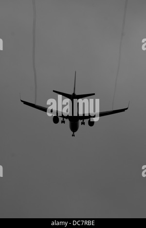 Aircraft on approach to airport with wake turbulence vortices in fog ...