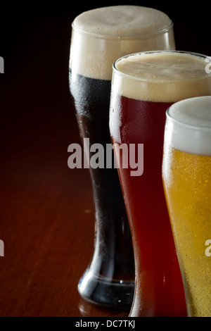 dark, red and light beer served on a dark bar Stock Photo - Alamy