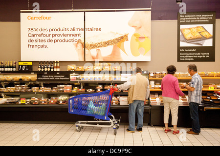 People shopping, the interior of a french Carrefour supermarket, the ...