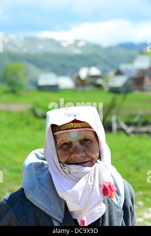 An old Dinaric highlander wearing traditional head wear and ornaments ...