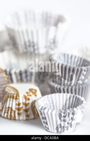 empty baking paper cups. white cookie paper cases isolated on yellow ...