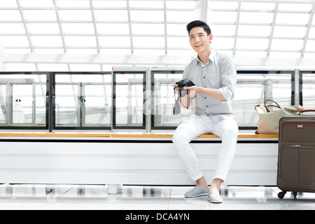 Young man with SLR camera at subway station Stock Photo - Alamy