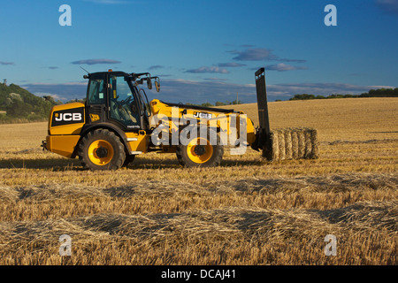 Stacking Straw bales with a JCB TM 130s during harvest UK Stock Photo ...