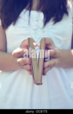 Student girl with open book reading it in university library Stock ...