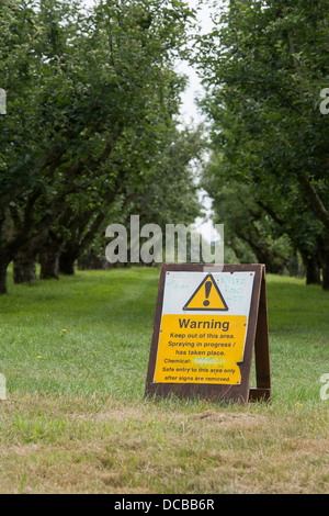 Spraying herbicide warning sign in the apple orchard at RHS Wisley ...