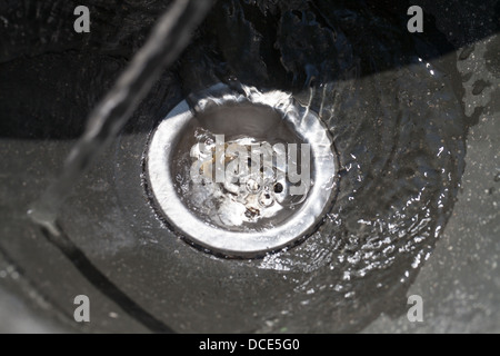 Water flows into drain hole, closeup Stock Photo - Alamy