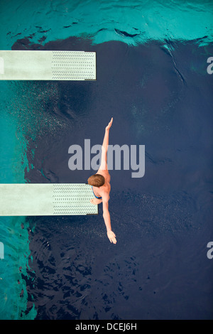 Man at the dive at the swimming pool of the springboard Stock Photo - Alamy