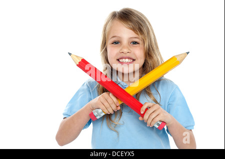 Primary school child posing with a big red pencil in hand,flashing a ...