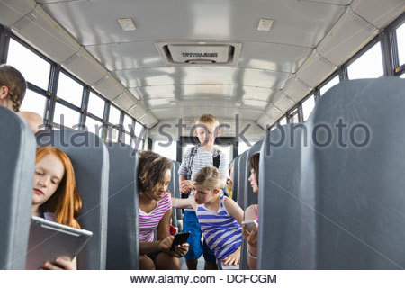 Children riding on school bus Stock Photo - Alamy