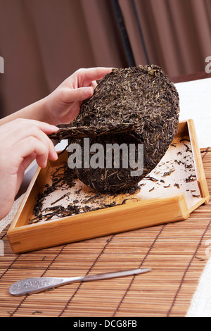 Professional cutting Pu'er tea Stock Photo - Alamy