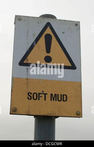 A 'soft mud' sign is pictured on the bank of the River Thames Stock ...