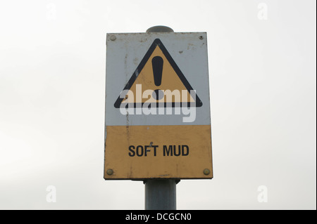 A 'soft mud' sign is pictured on the bank of the River Thames Stock ...