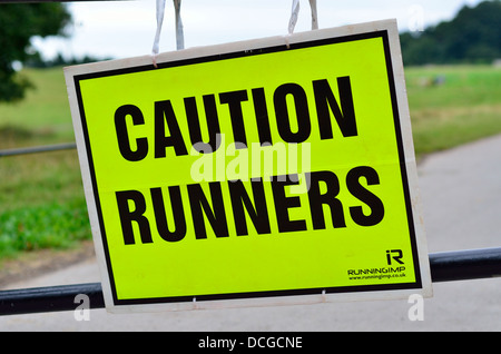 Caution runners sign Stock Photo - Alamy