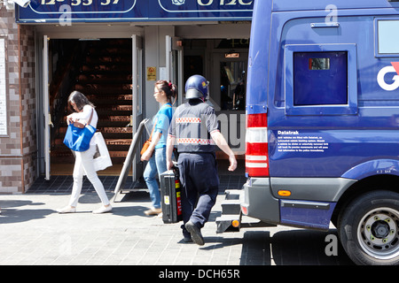 A guard from the Private Security company, SEPSA walks with his firearm ...