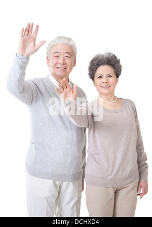 Two Asian men waving at camera while streaming online content with ...