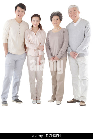 Portrait of loving young family of four on small bridge in the park ...