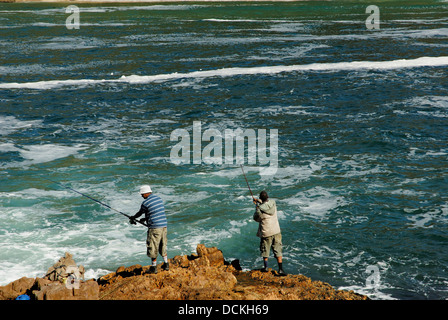 South Africa, Knysna, 2009. Fishermen fishing at The Heads, as the tide ...