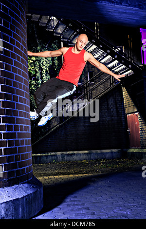 Acrobat man training parkour in abandoned factory Stock Photo - Alamy
