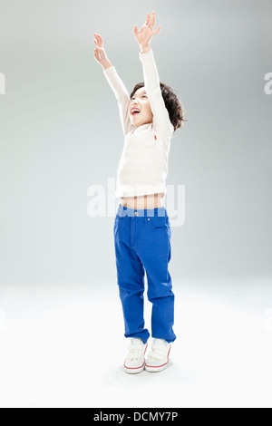 a boy jumping to reach something Stock Photo - Alamy