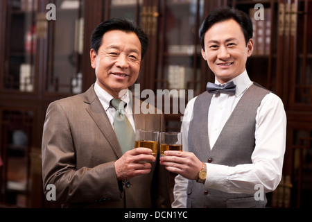 Men with whiskey toasting at entertainment club Stock Photo - Alamy