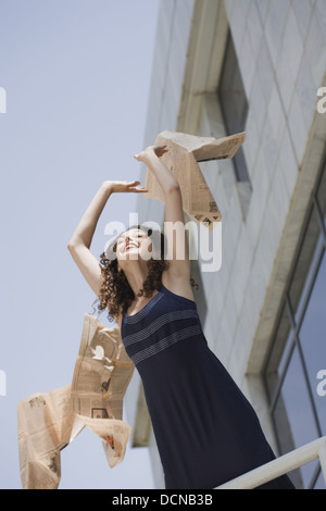 Happy businesswoman throwing newspaper in the air Stock Photo - Alamy