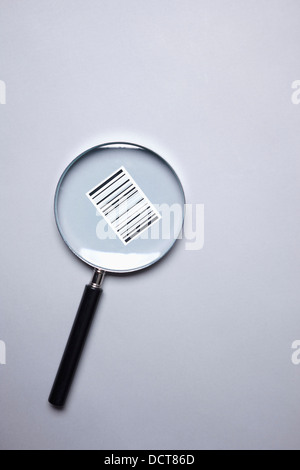 Bar code under a magnifying glass Stock Photo - Alamy