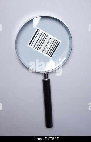 Bar code under a magnifying glass Stock Photo - Alamy